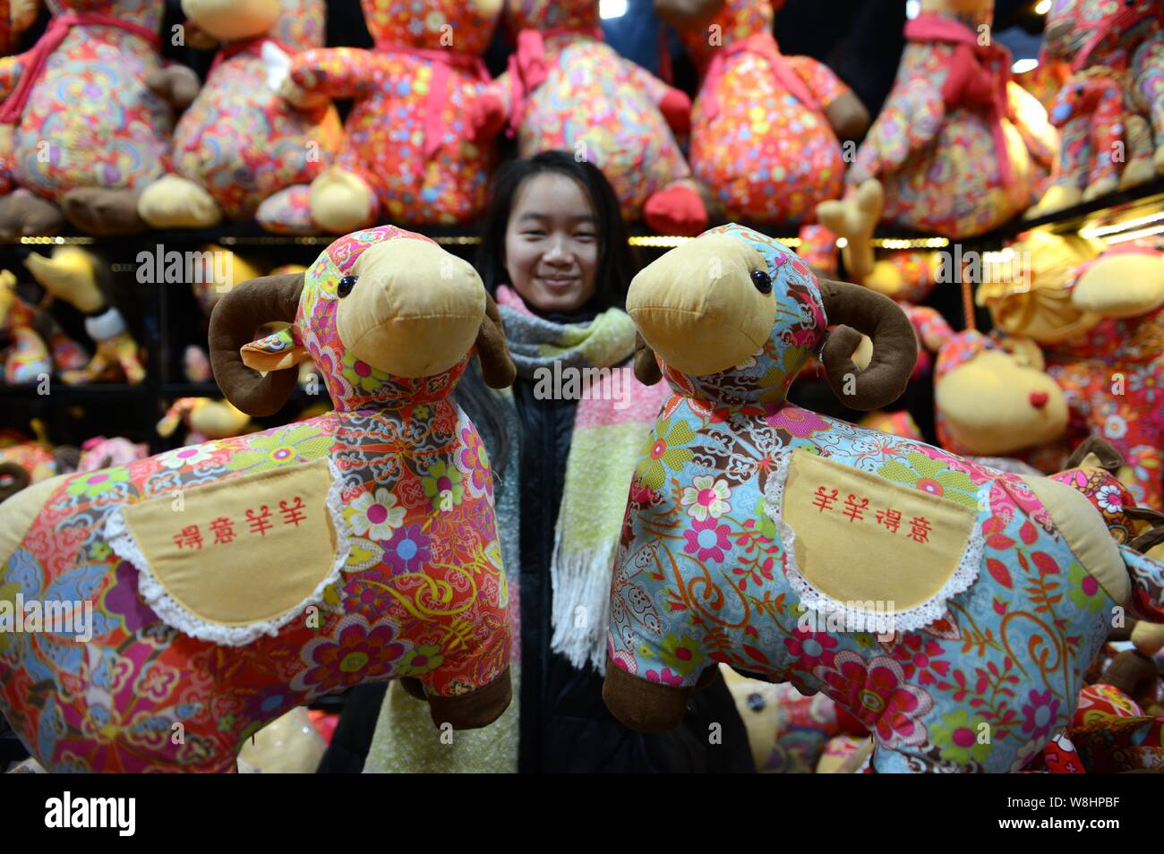 --FILE--A local Chinese resident buys toy sheep for Spring Festival to ...