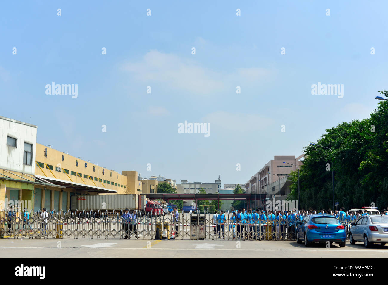 Chinese workers crowd at the entrance of the factory of Kinpo ...
