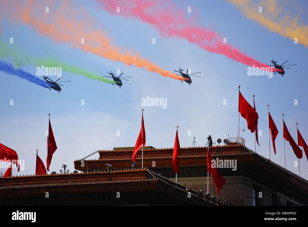 Military helicopters fly in formation over Tiananmen Square during the ...