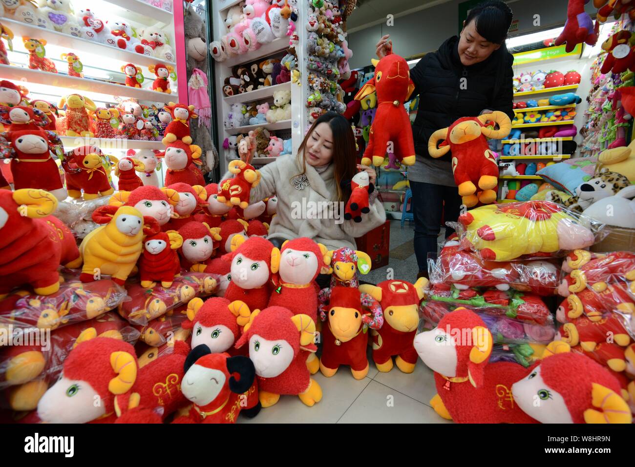 --FILE--A local Chinese resident buys toy sheep for Spring Festival to ...