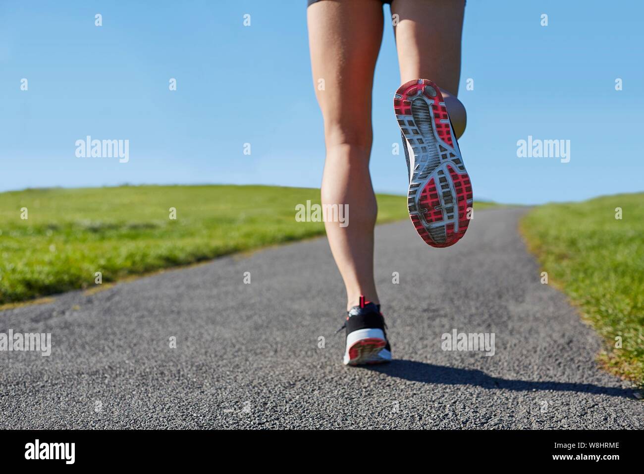 Woman jogging on a path Stock Photo - Alamy