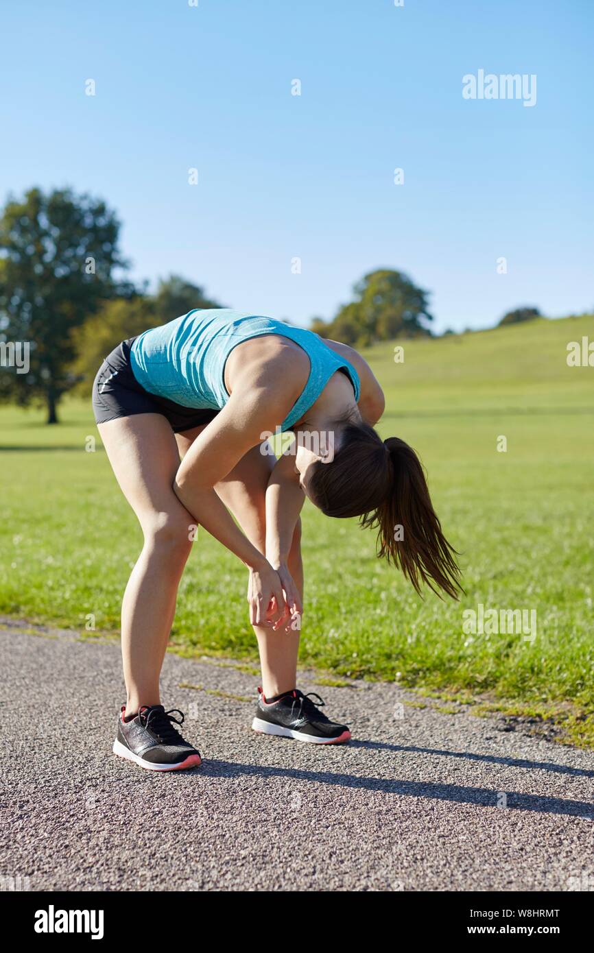 Woman recovering after exercise Stock Photo - Alamy