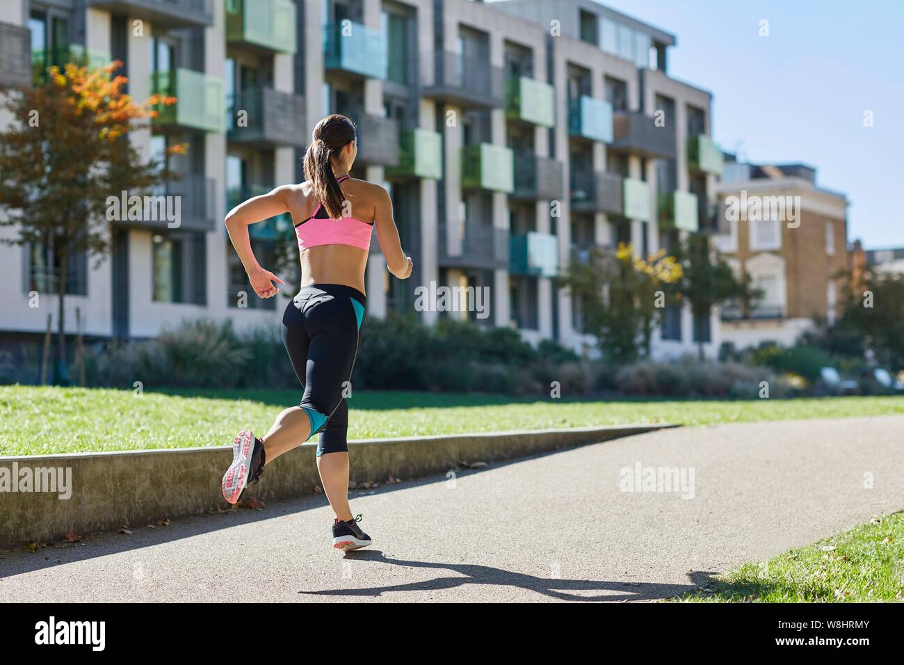 Young woman jogging Stock Photo - Alamy