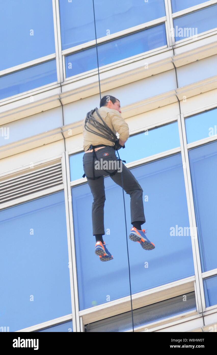 British adventurer and television presenter Bear Grylls abseils from a ...