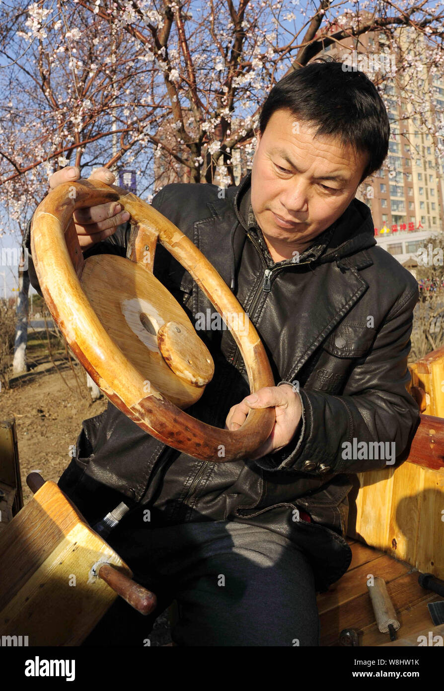 Chinese carpenter Liu Fulong installs the steering wheel on his third ...