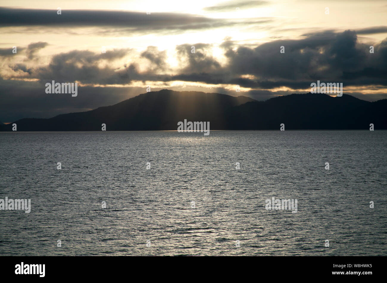 Midday sun shaft on water Stock Photo - Alamy