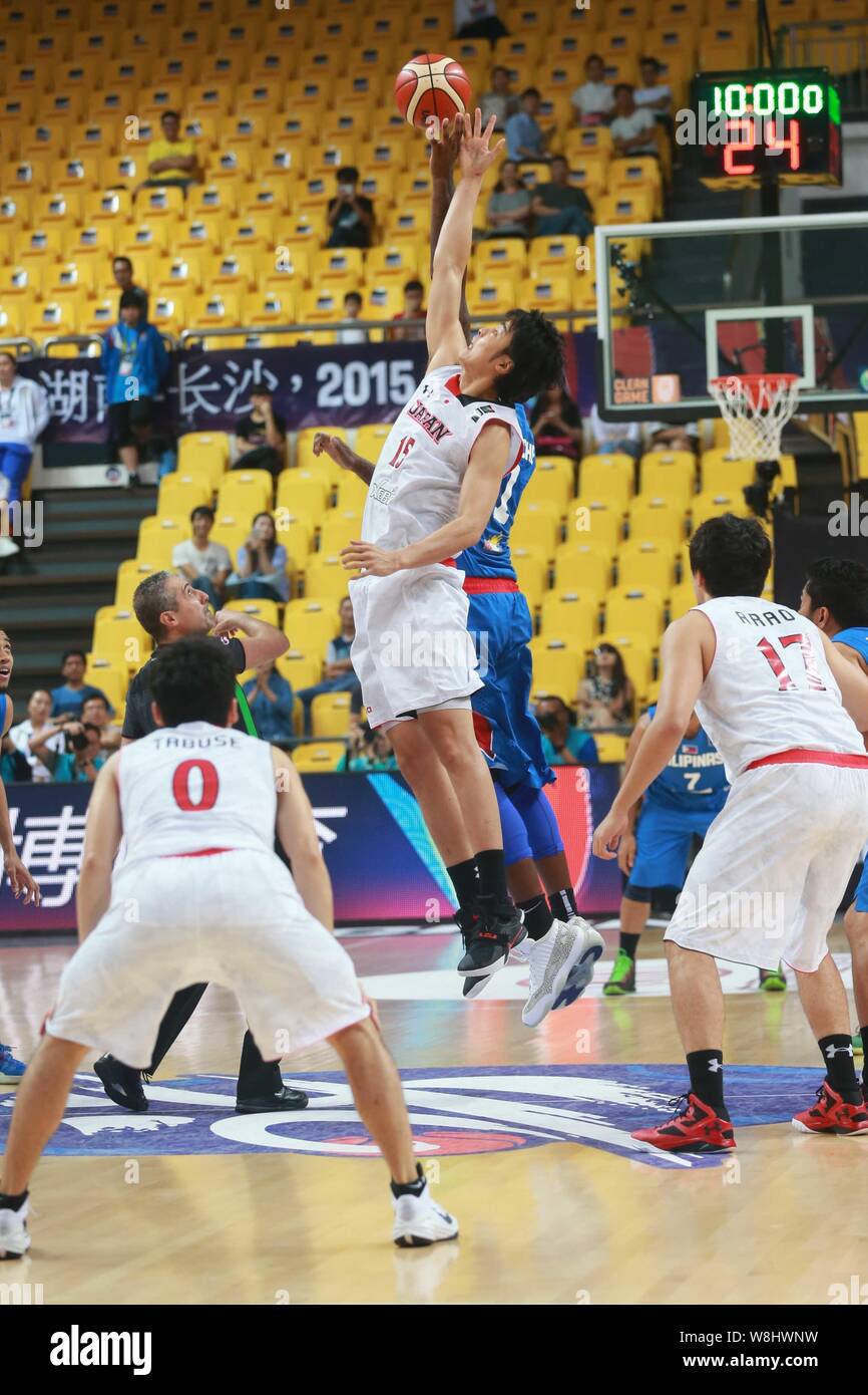Joji Takeuchi of Japan, center, challenges a player of Philippines in a ...