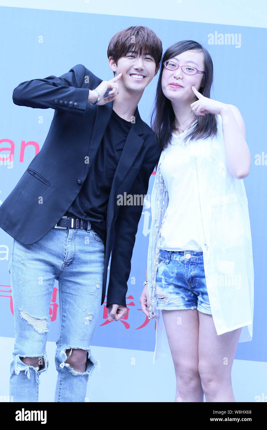 Hwang Kwang-hee of South Korean boyband ZE:A, left, poses with a fan ...