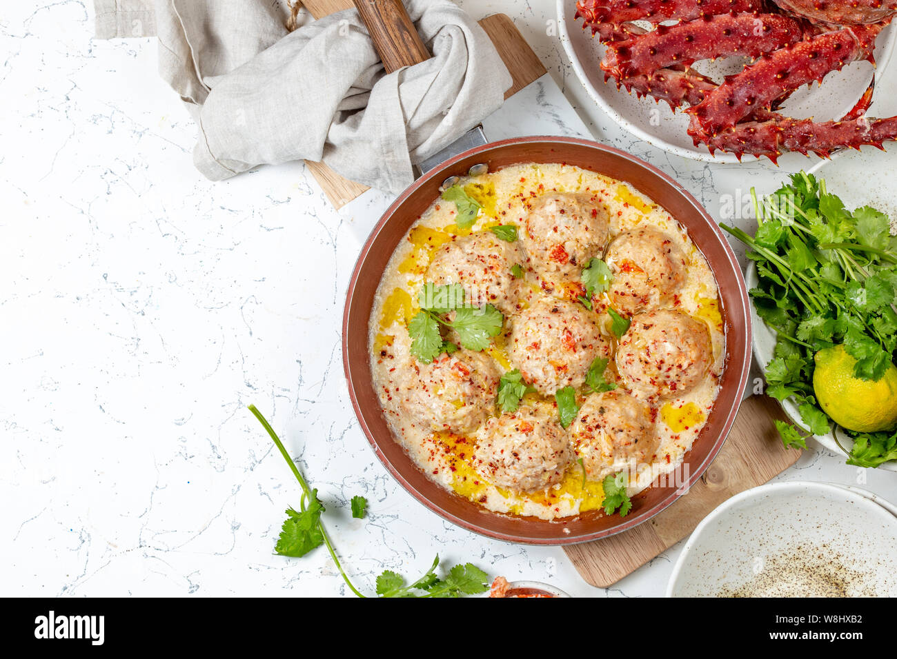 CRABMEATBALLS crab meatballs in white creamy sauce in red pan, whole ...