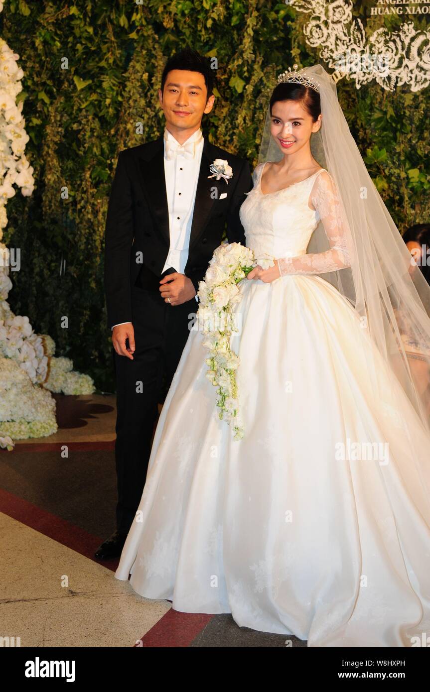 Chinese actor Huang Xiaoming, left, and his actress wife Angelababy ...