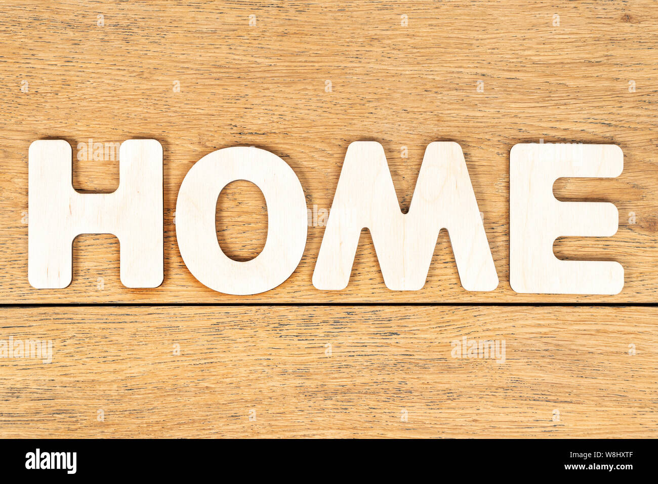 Word - home, laid out letters on an old wooden oak board Stock Photo ...