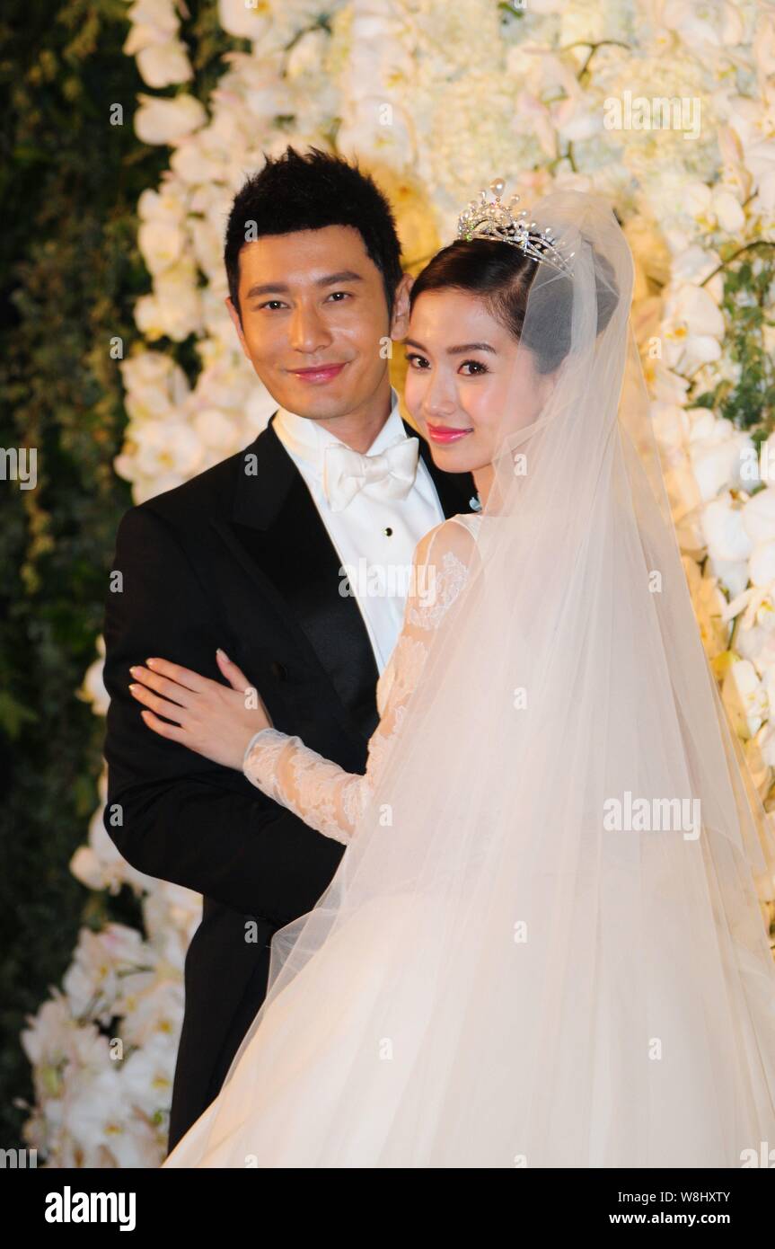Chinese actor Huang Xiaoming, left, and his actress wife Angelababy pose during their wedding ...