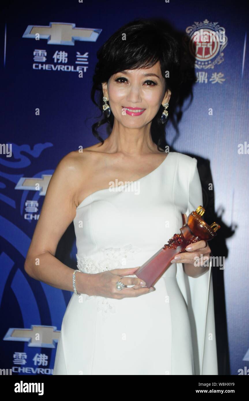 Hong Kong actress Angie Chiu poses with her trophy during the 17th ...