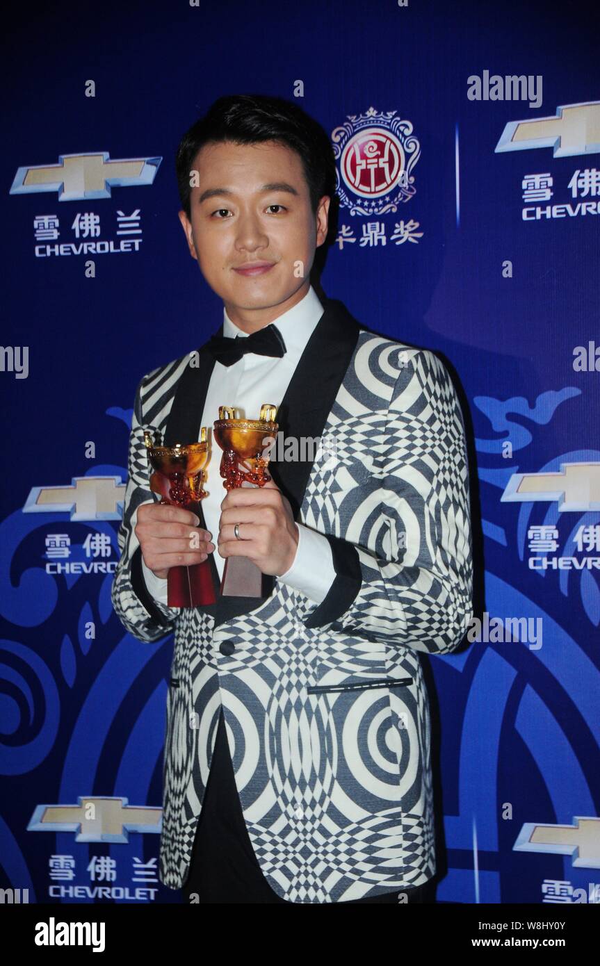 Chinese actor Tong Dawei poses with his trophies during the 17th ...