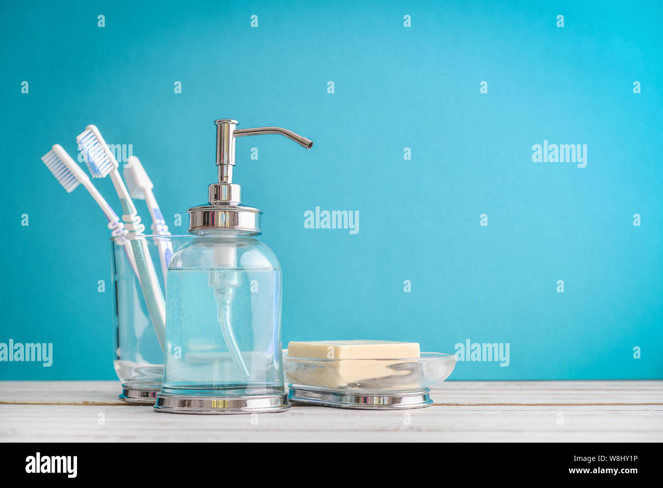 Bathroom set with toothbrushes and soap on blue background Stock Photo ...