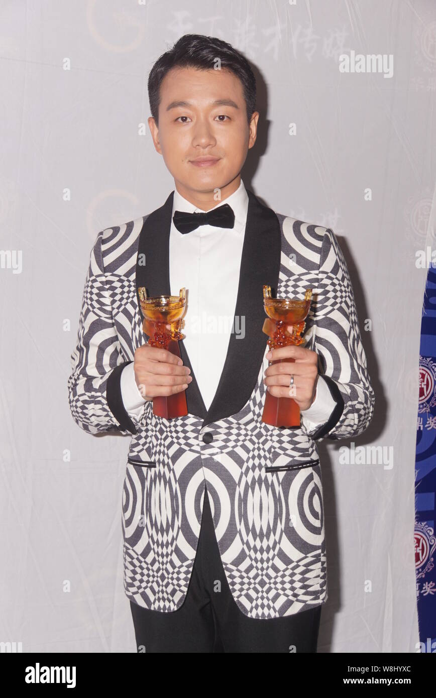Chinese actor Tong Dawei poses with his trophies during the 17th ...