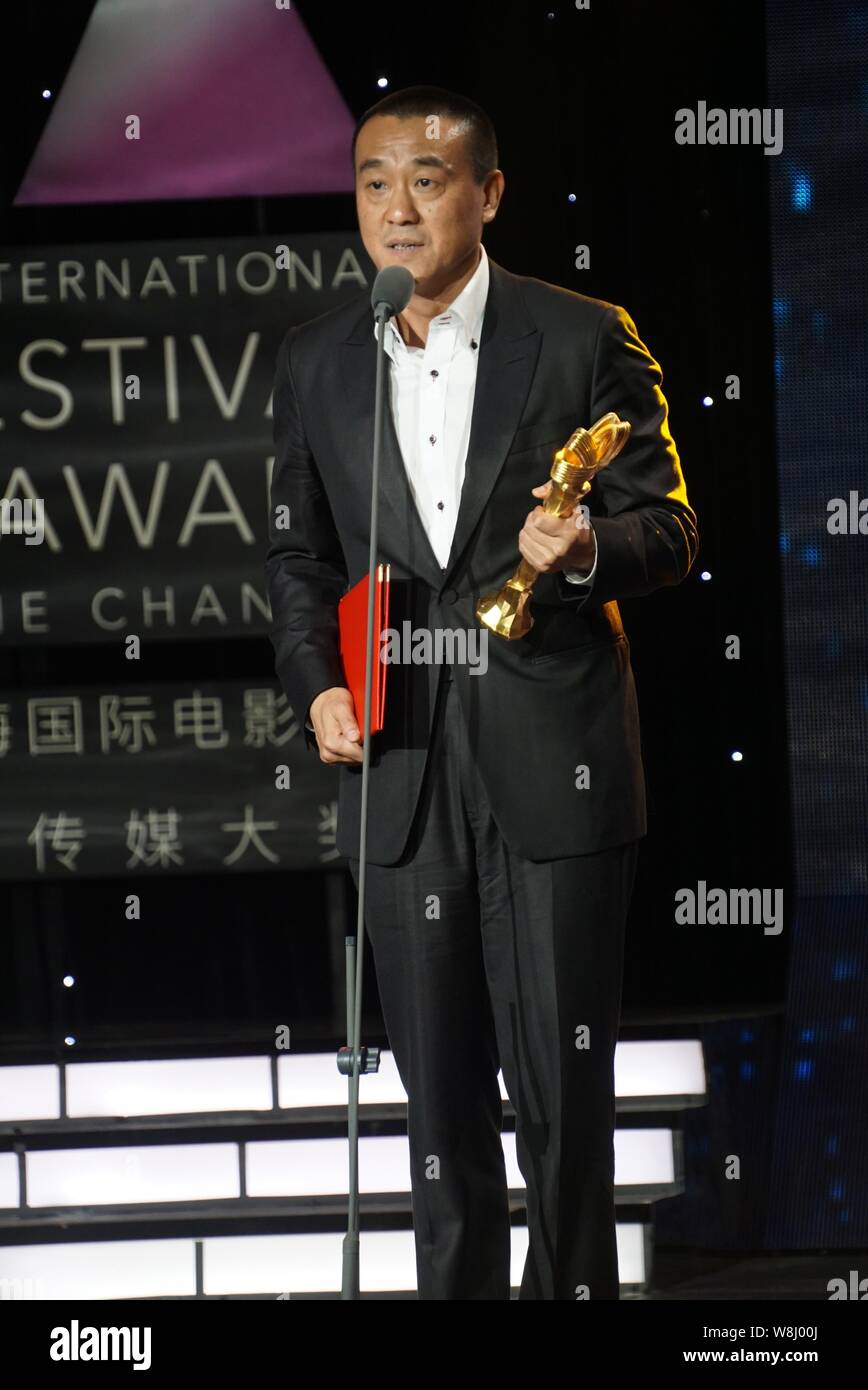 Chinese actor He Bing speaks as he holds the trophy for the Best Actor ...