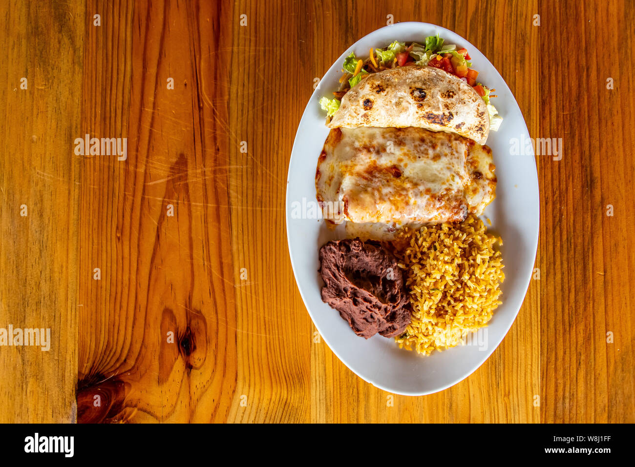 Chicken Enchilada plate with rice, beans and chicken taco Stock Photo ...