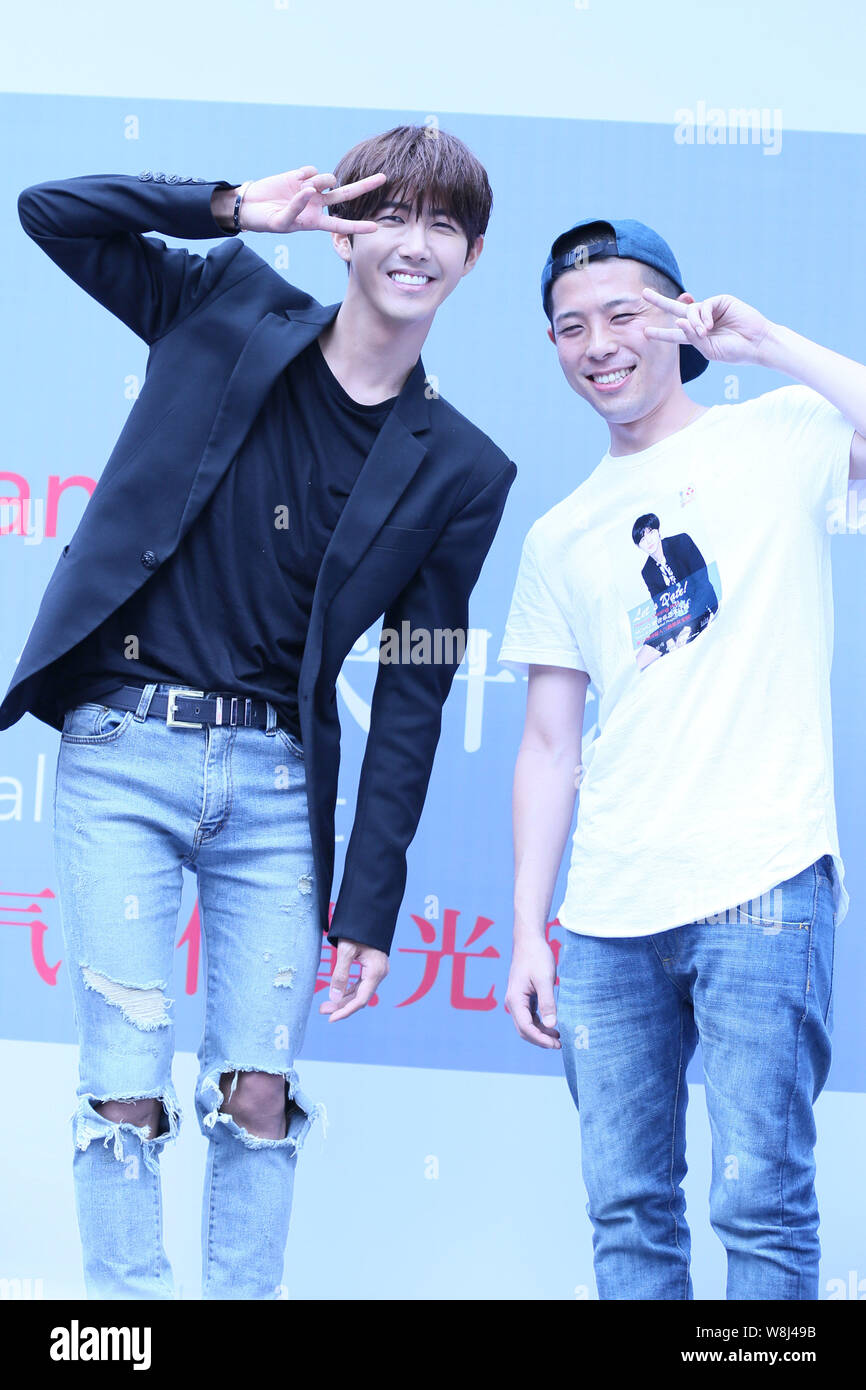 Hwang Kwang-hee of South Korean boyband ZE:A, left, poses with a fan ...
