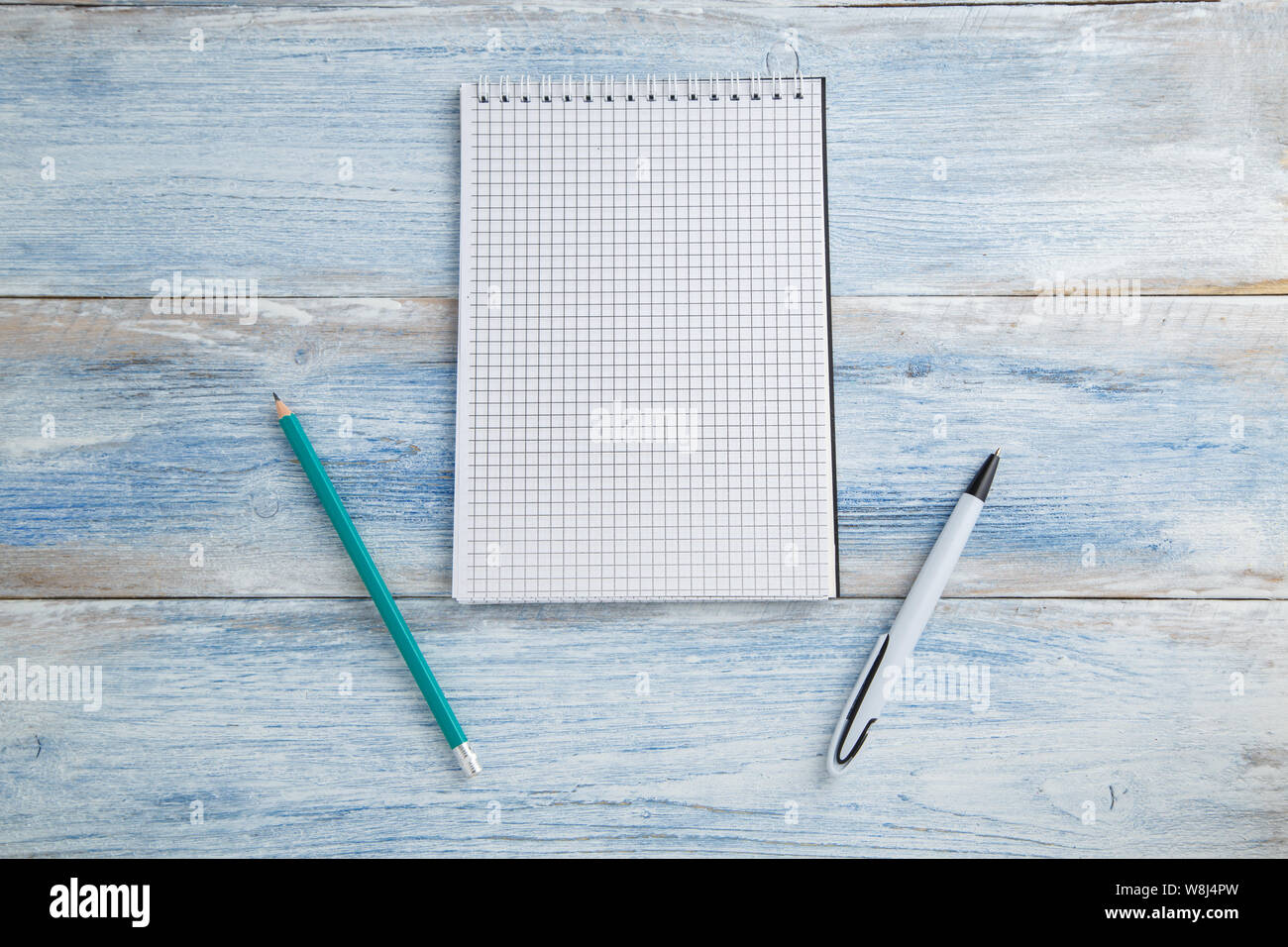 notebook with pen or pencil on a blue and white shabby vintage wooden ...
