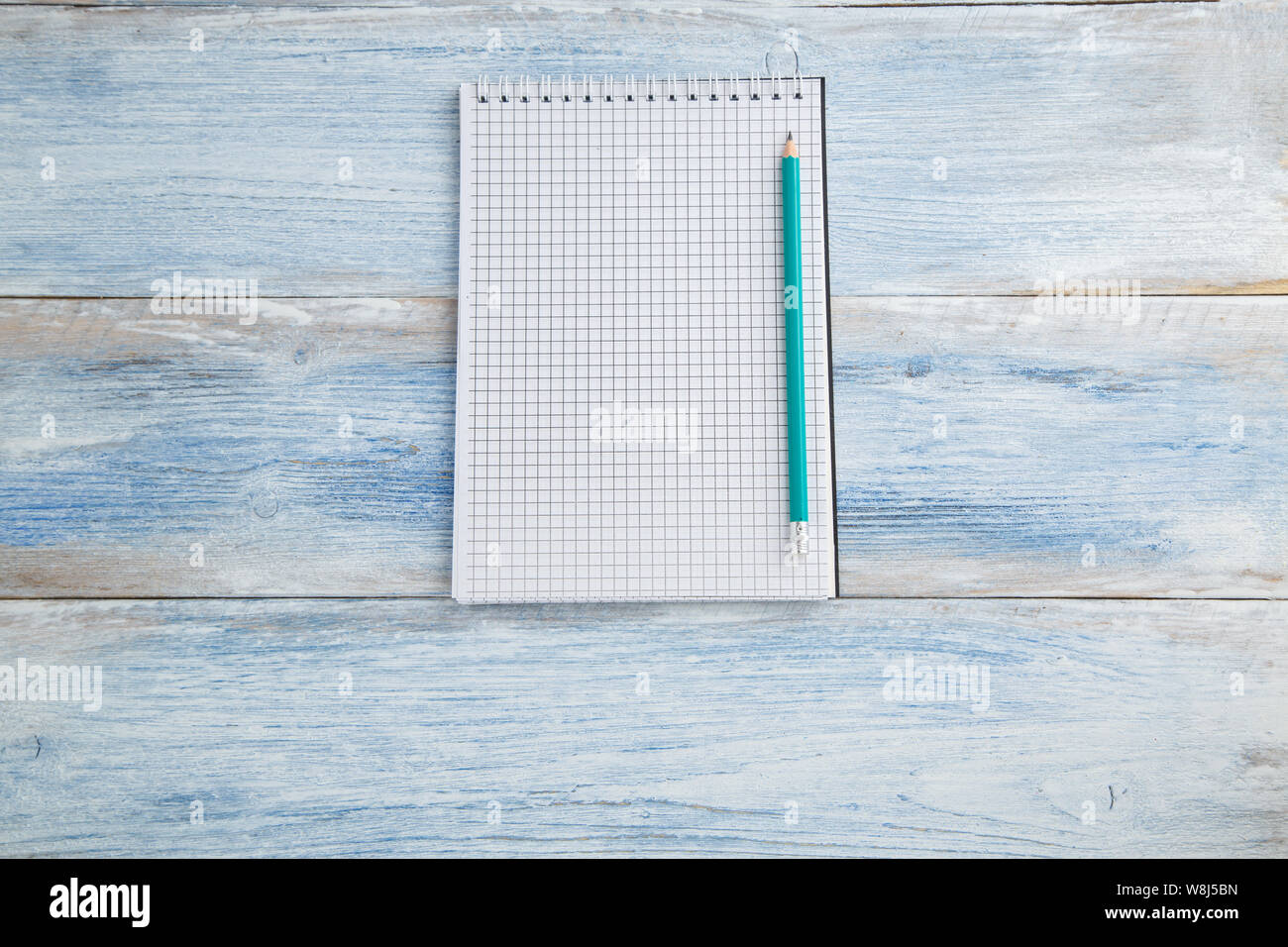 notebook with pen or pencil on a blue and white shabby vintage wooden ...