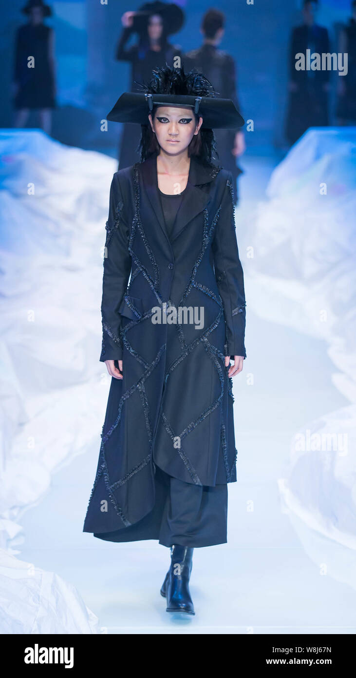 A model displays a new creation designed by Liu Shixi at the "The ...