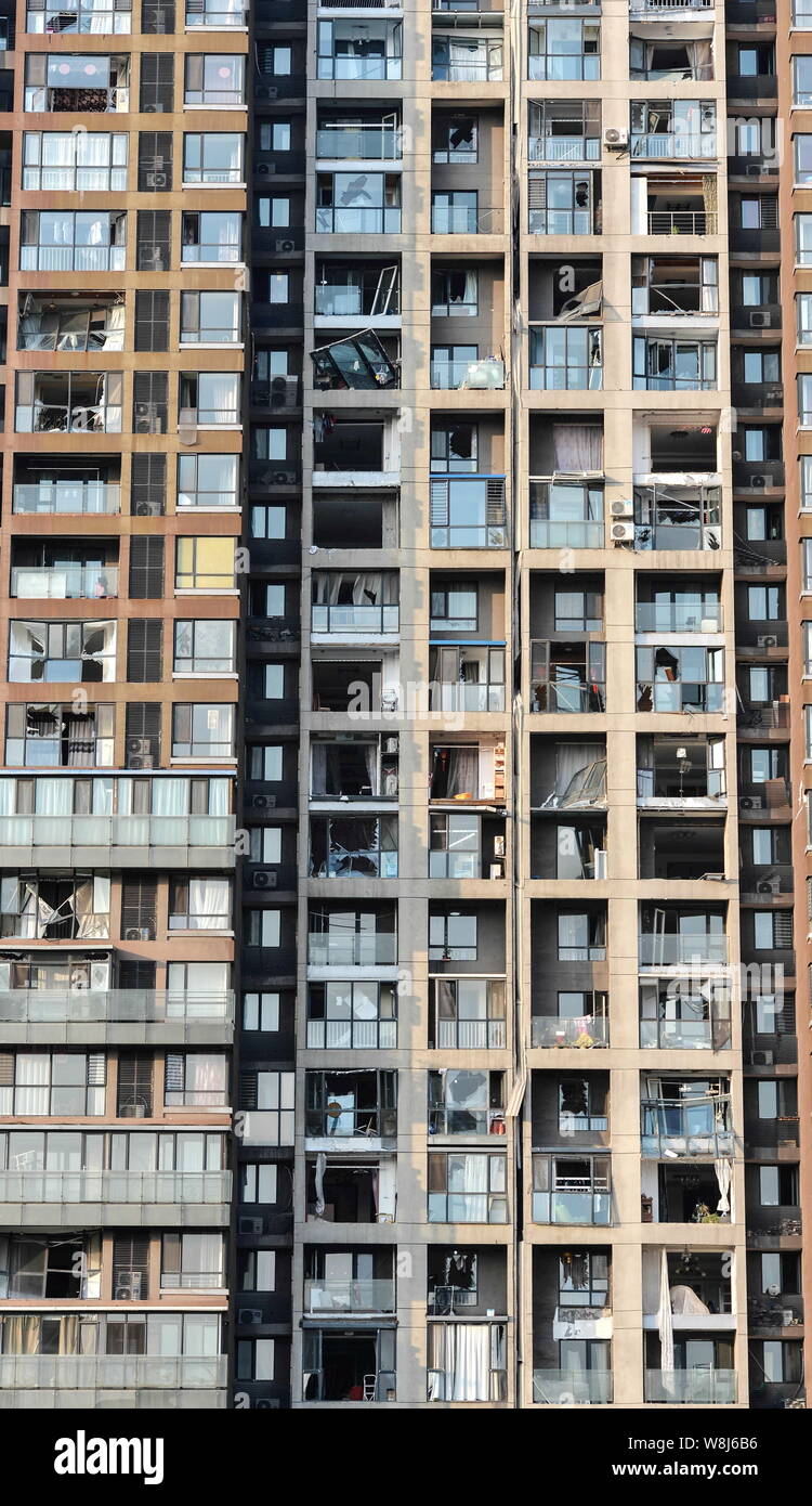 Windows are broken on a high-rise residential apartment building ...