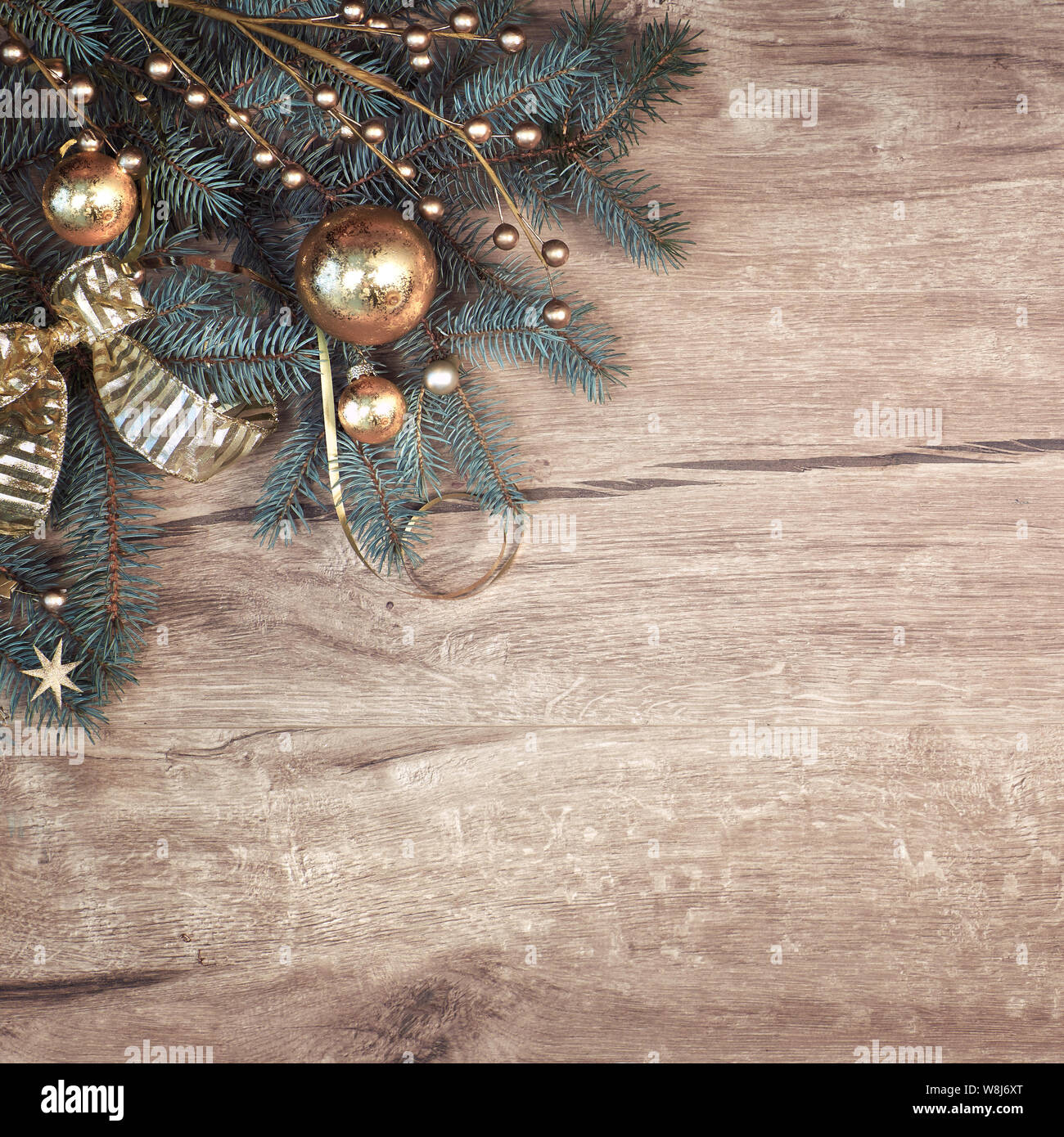 Christmas background on wood with a corner of decorated fir tree ...