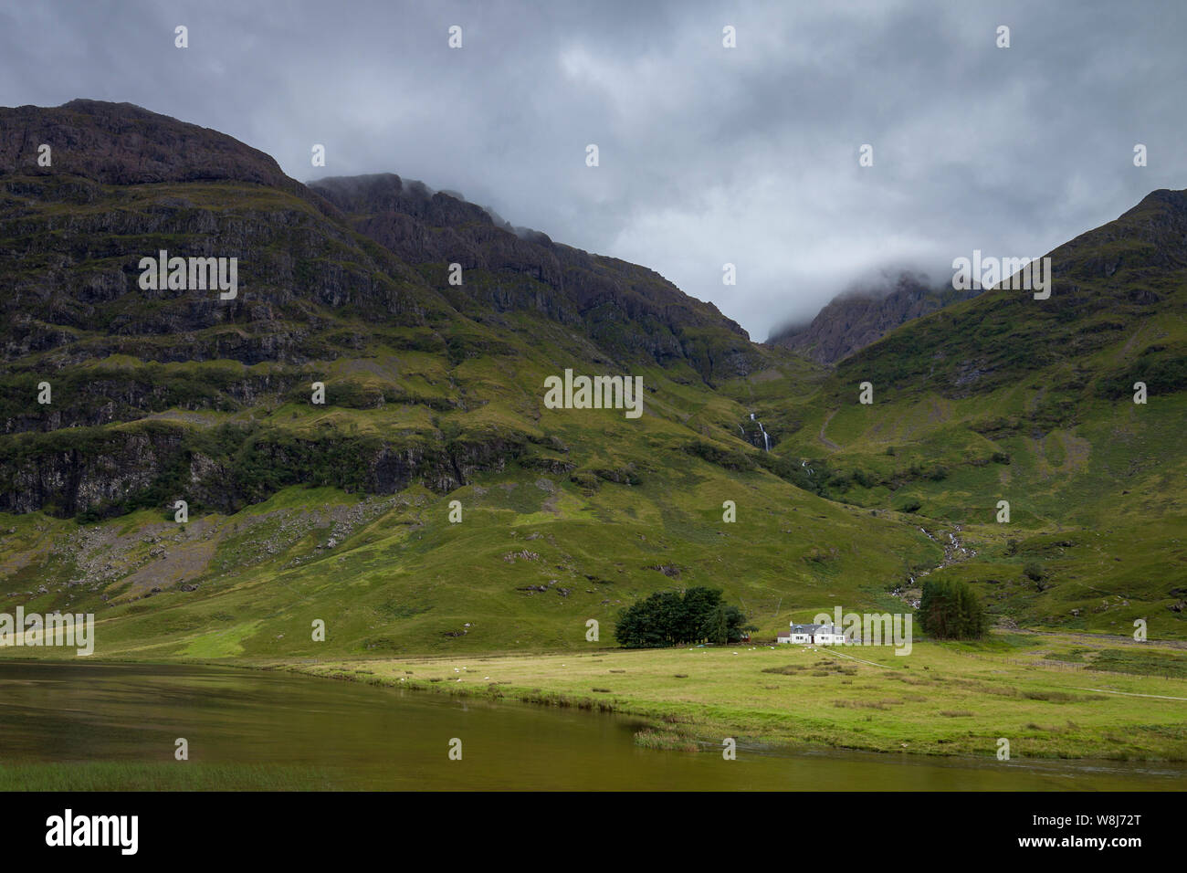 A scenic landscape of a remote house surrounded by a loch (Loch ...