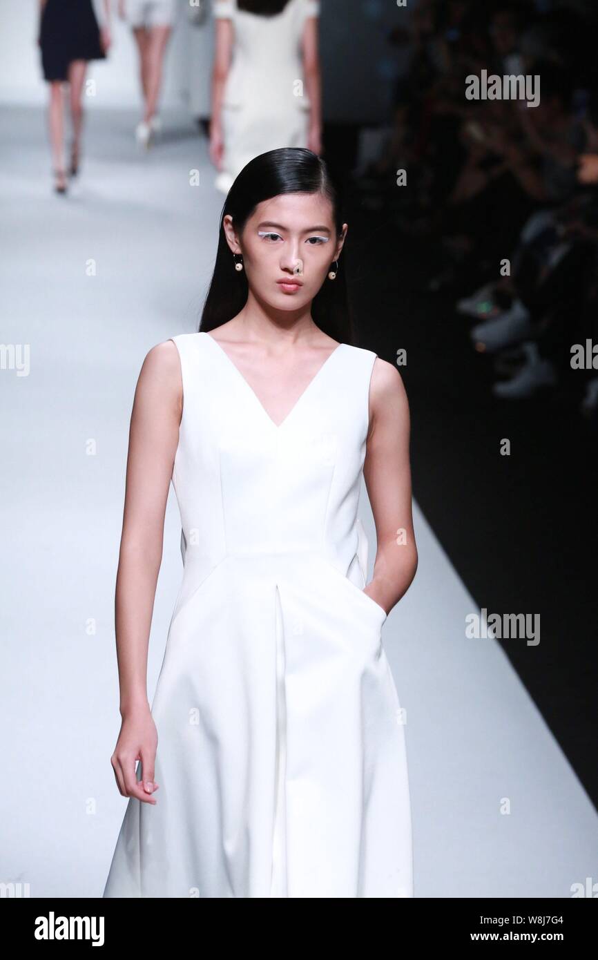 A model displays a new creation at the fashion show of Chinese fashion ...