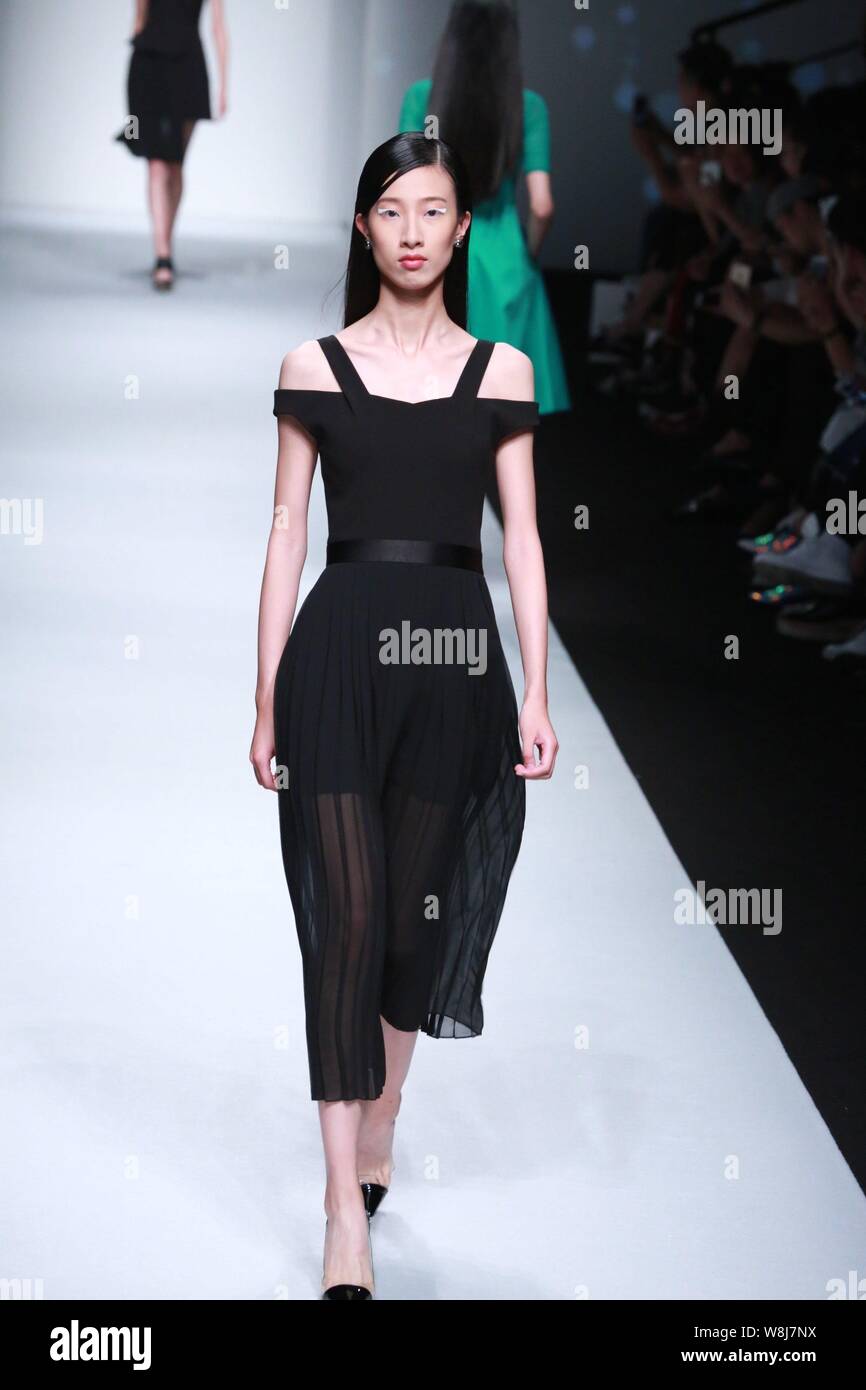 A model displays a new creation at the fashion show of Chinese fashion ...