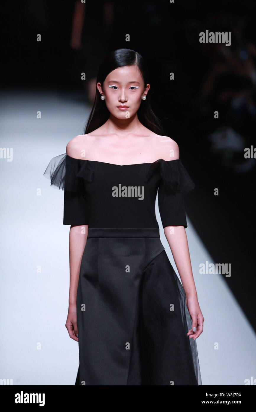 A model displays a new creation at the fashion show of Chinese fashion ...
