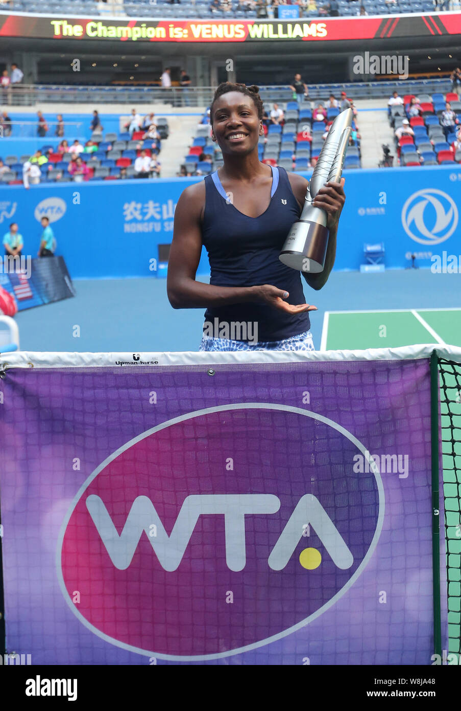 Venus Williams of the United States poses with her champion trophy ...