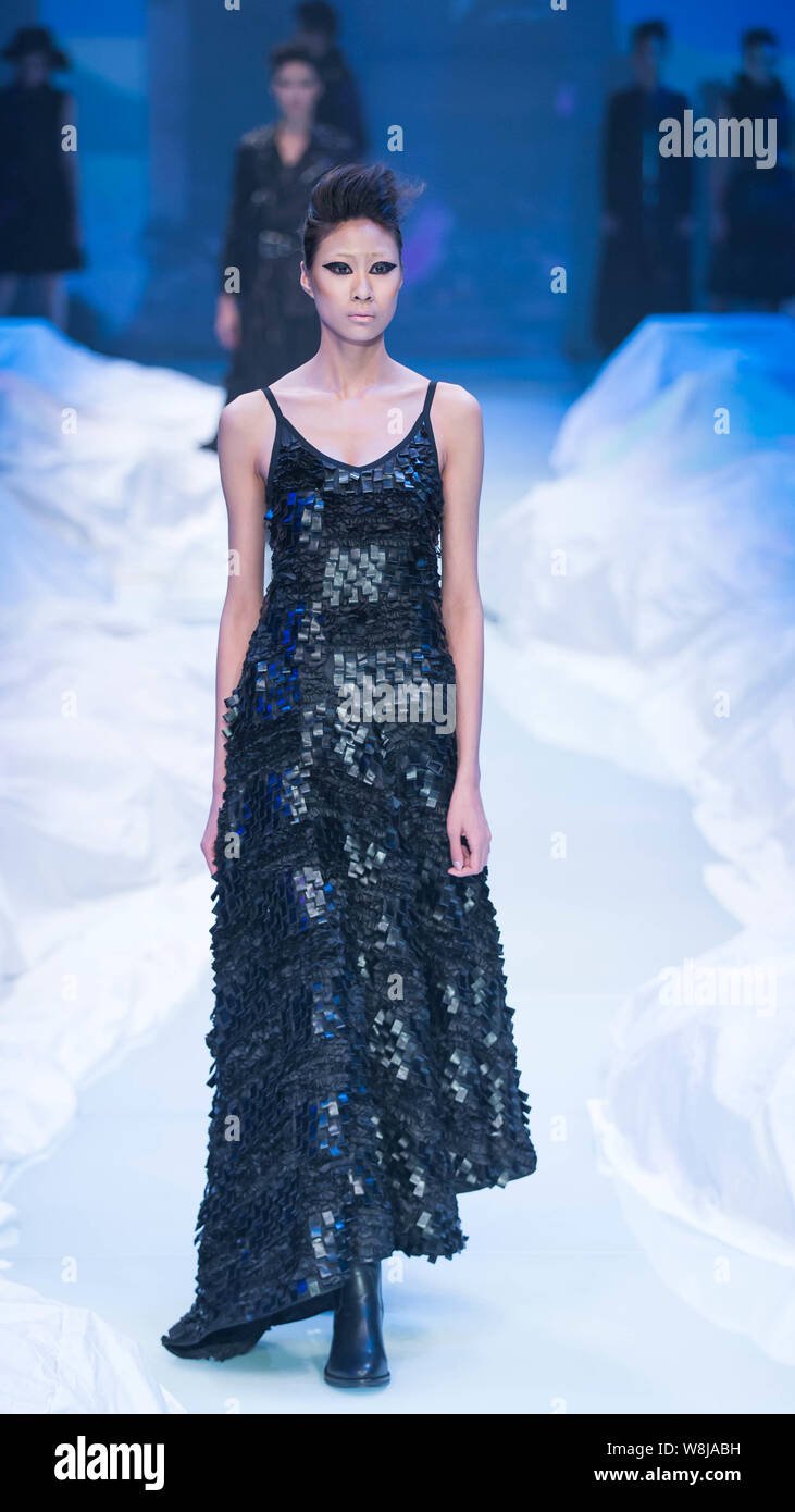 A model displays a new creation designed by Liu Shixi at the "The ...