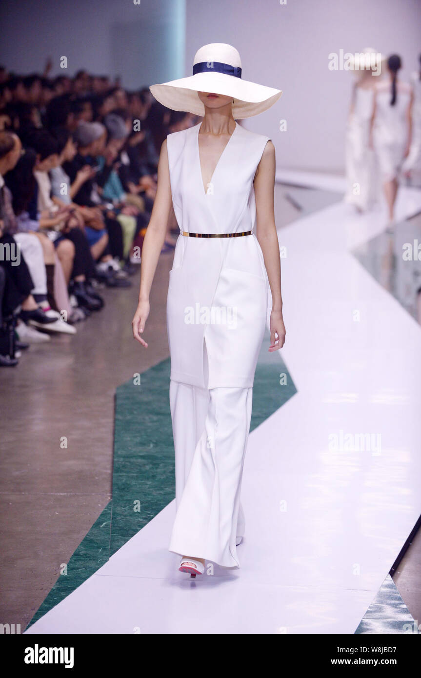 A model displays a new creation at the fashion show for the Spring ...