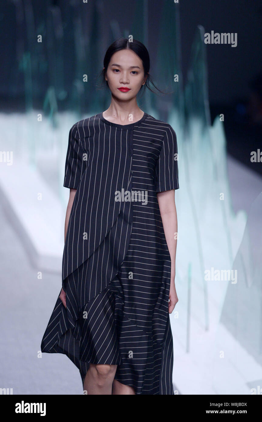 A model displays a new creation by Chinese designer Zhu Chongyun at a ...