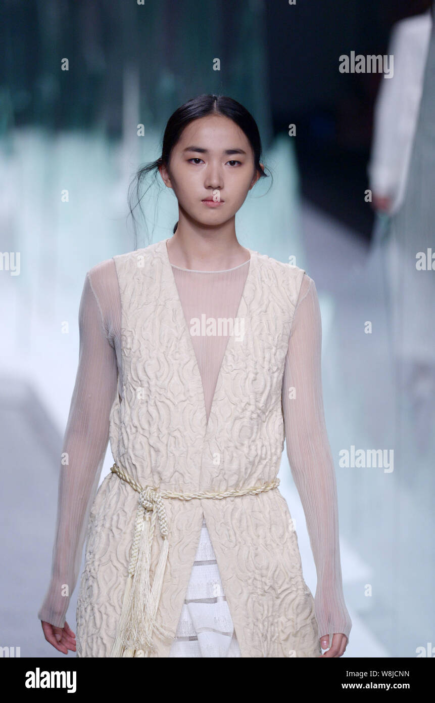 A model displays a new creation by Chinese designer Zhu Chongyun at a ...