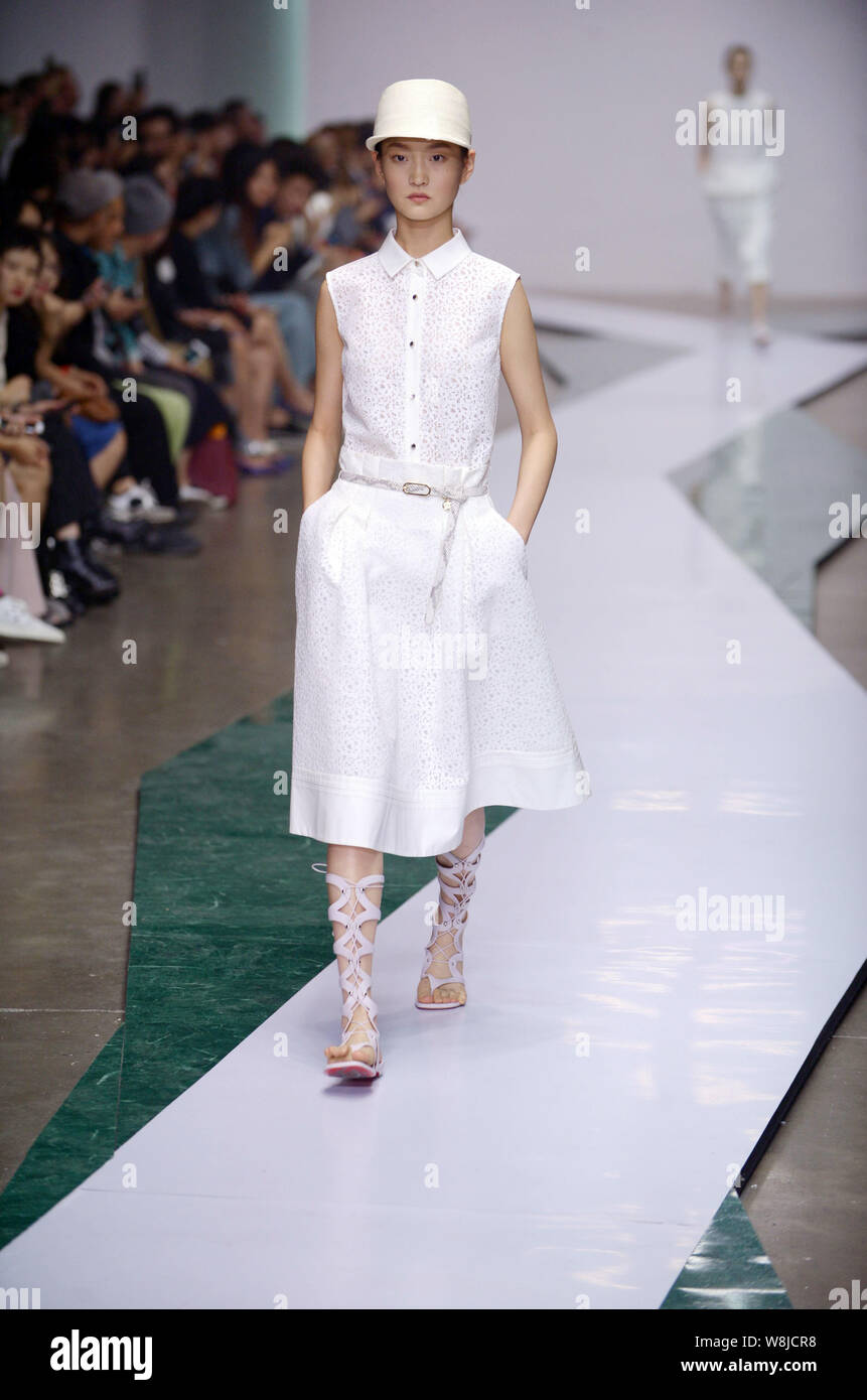 A model displays a new creation at the fashion show for the Spring ...