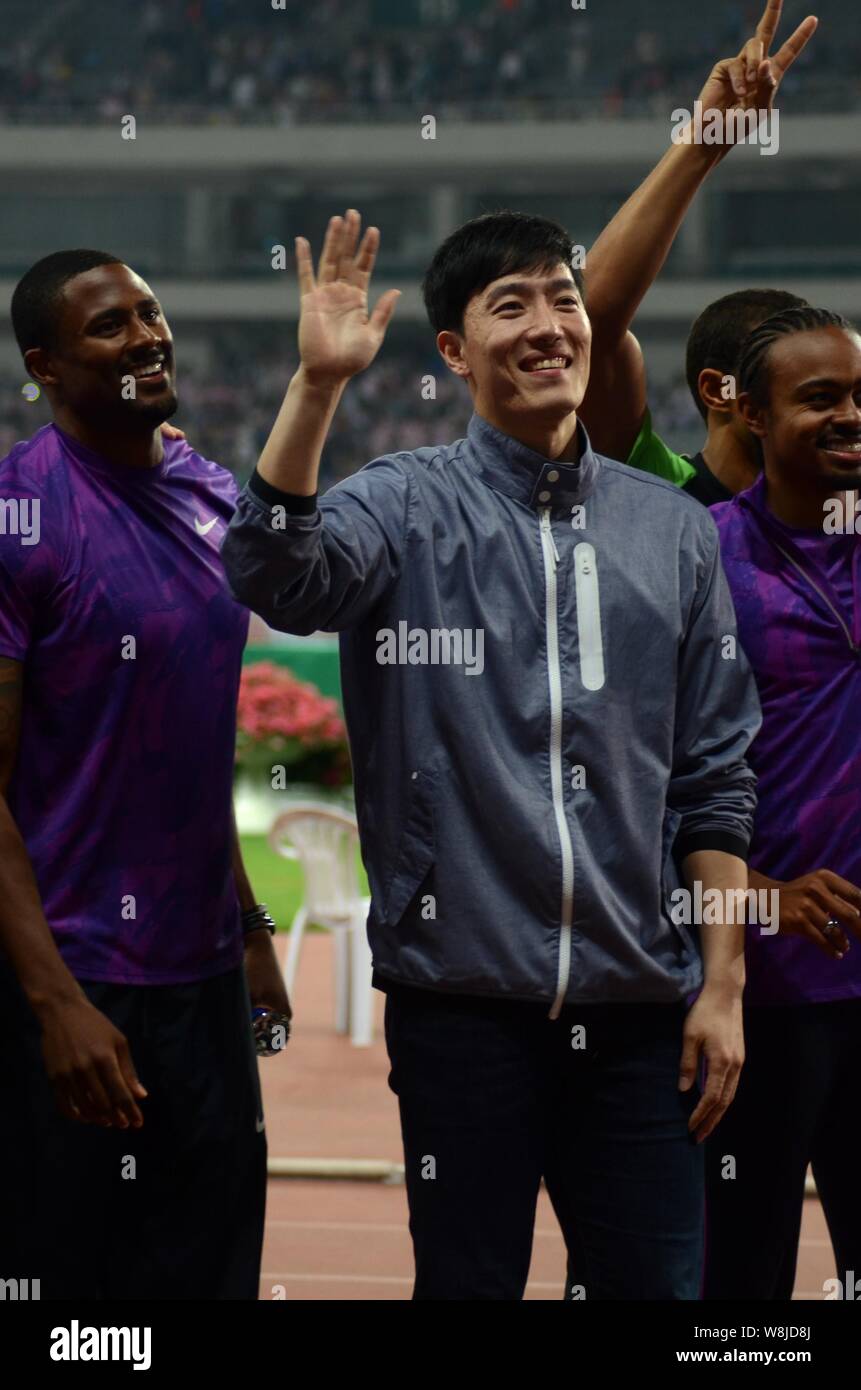 Chinese hurdler Liu Xiang, center, waves during his retirement ceremony ...