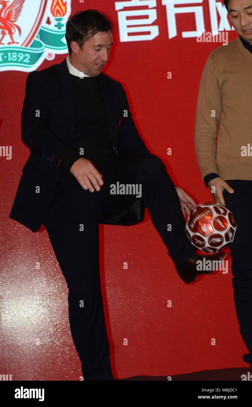 Retired English soccer player Robbie Fowler, left, shows his soccer ...