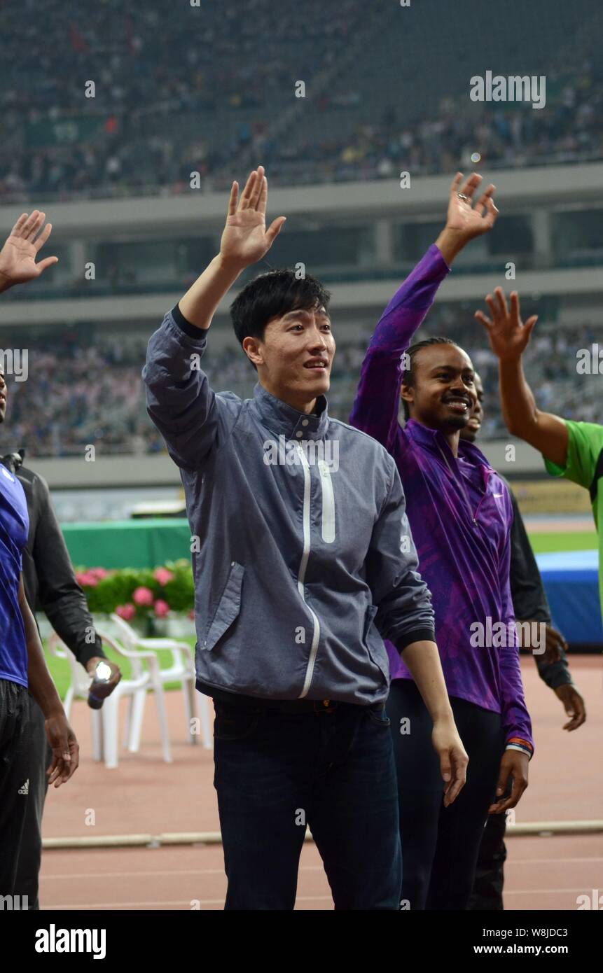 Chinese hurdler Liu Xiang, left, waves during his retirement ceremony ...