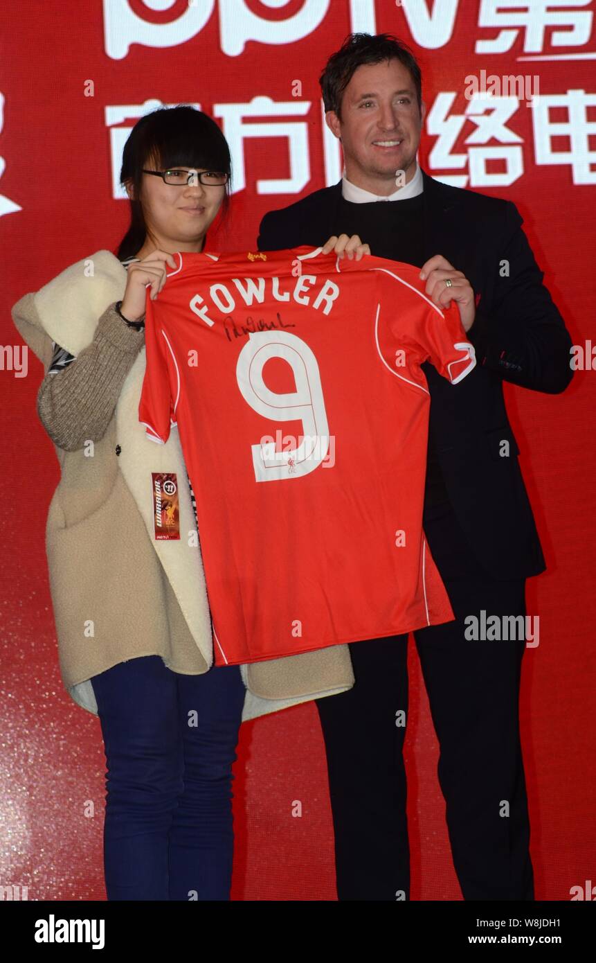 Retired English soccer player Robbie Fowler, right, poses with a ...
