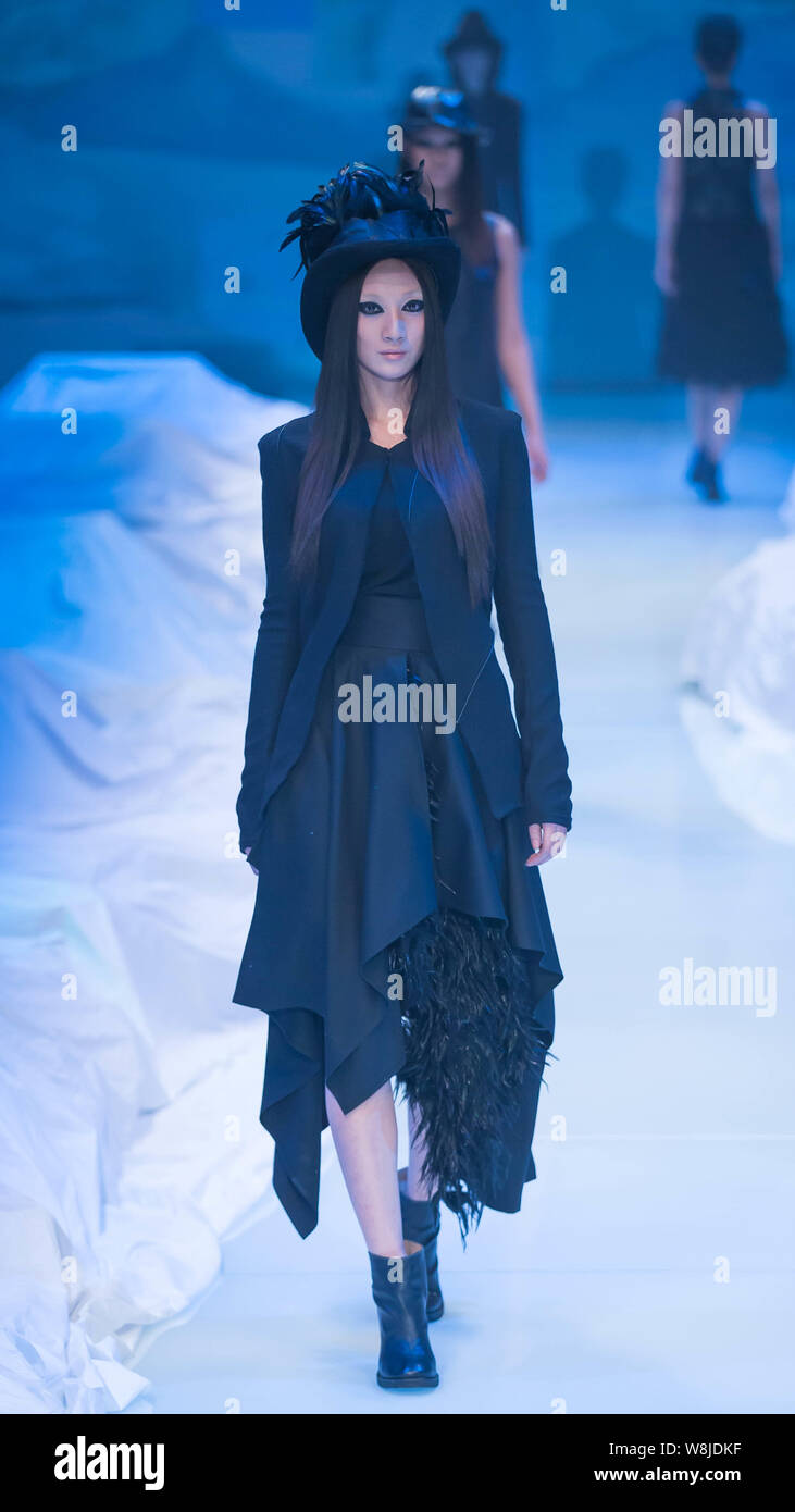 A model displays a new creation designed by Liu Shixi at the "The ...