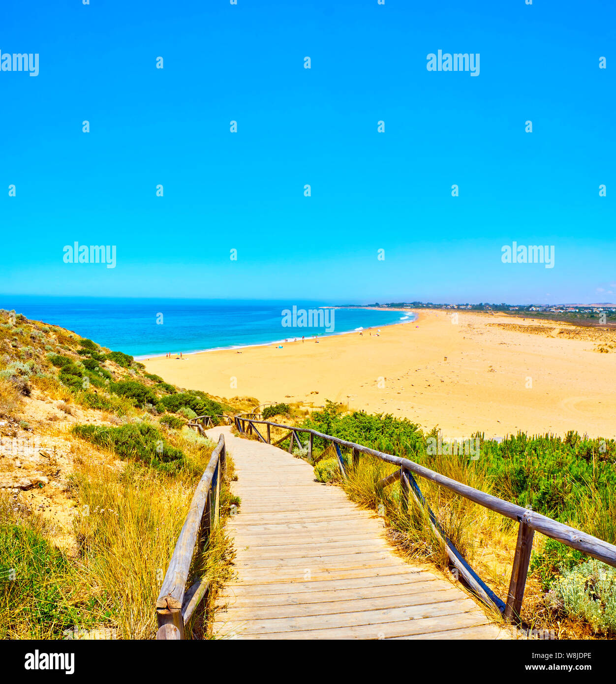 Wooden boardwalk going to Faro de Trafalgar Beach, a broad beach of The ...