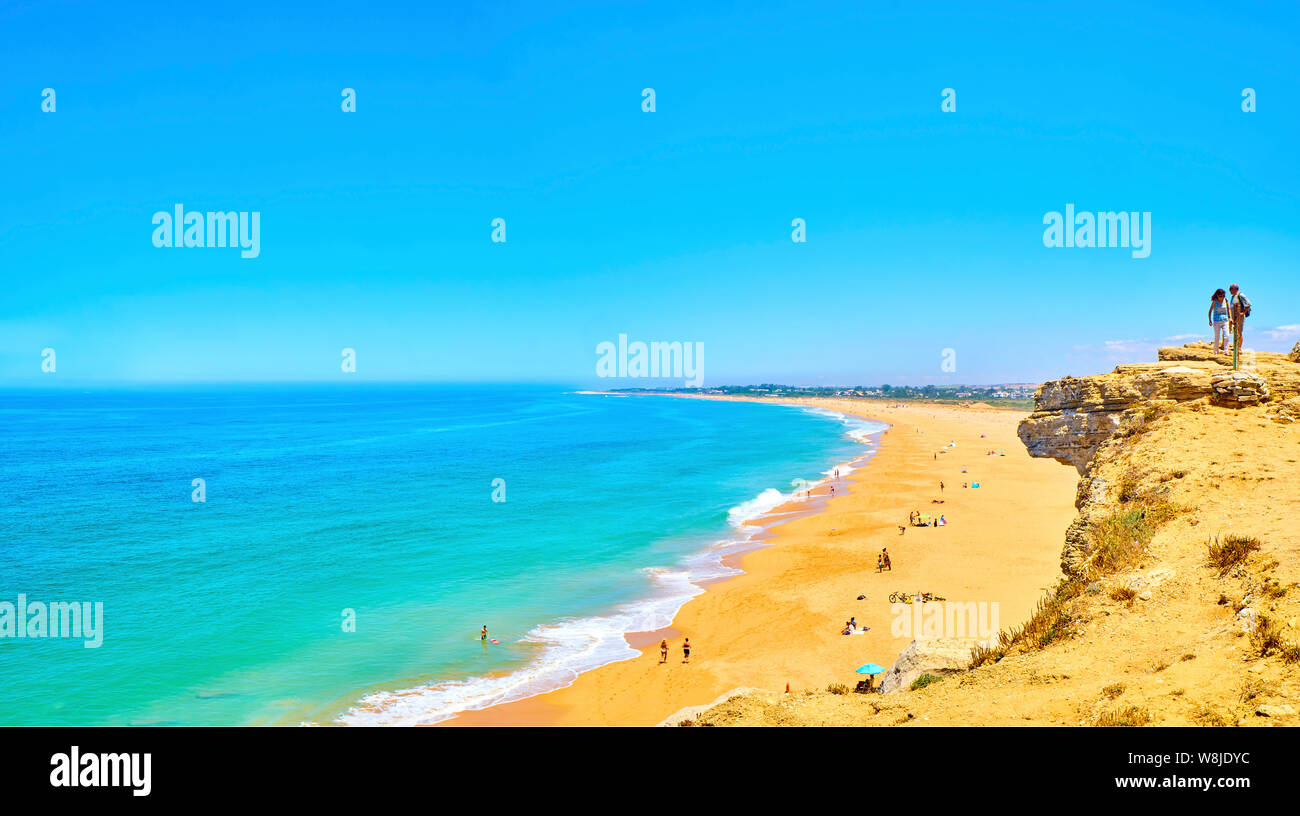 Tourists watching to The Faro de Trafalgar Beach, a broad beach of The ...