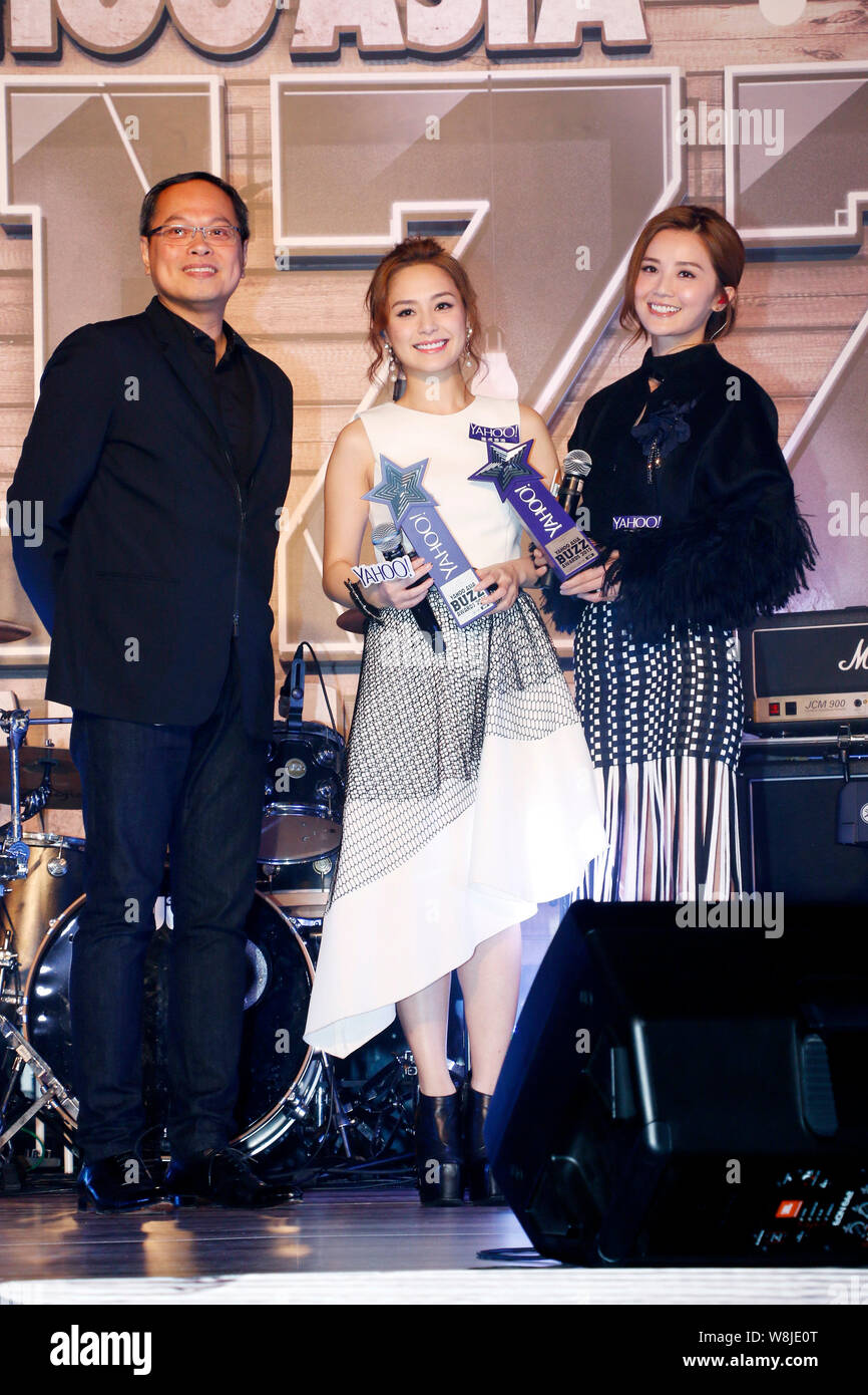 Singers and actresses Gillian Chung, center, and Charlene Choi, right ...