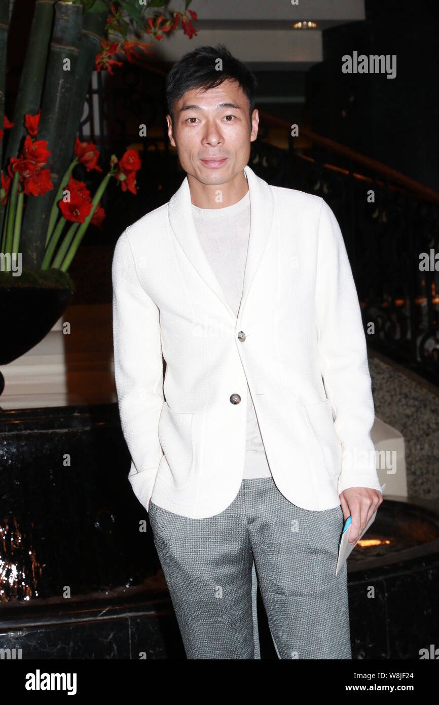 Hong Kong singer Andy Hui poses as he arrives for the wedding party of ...