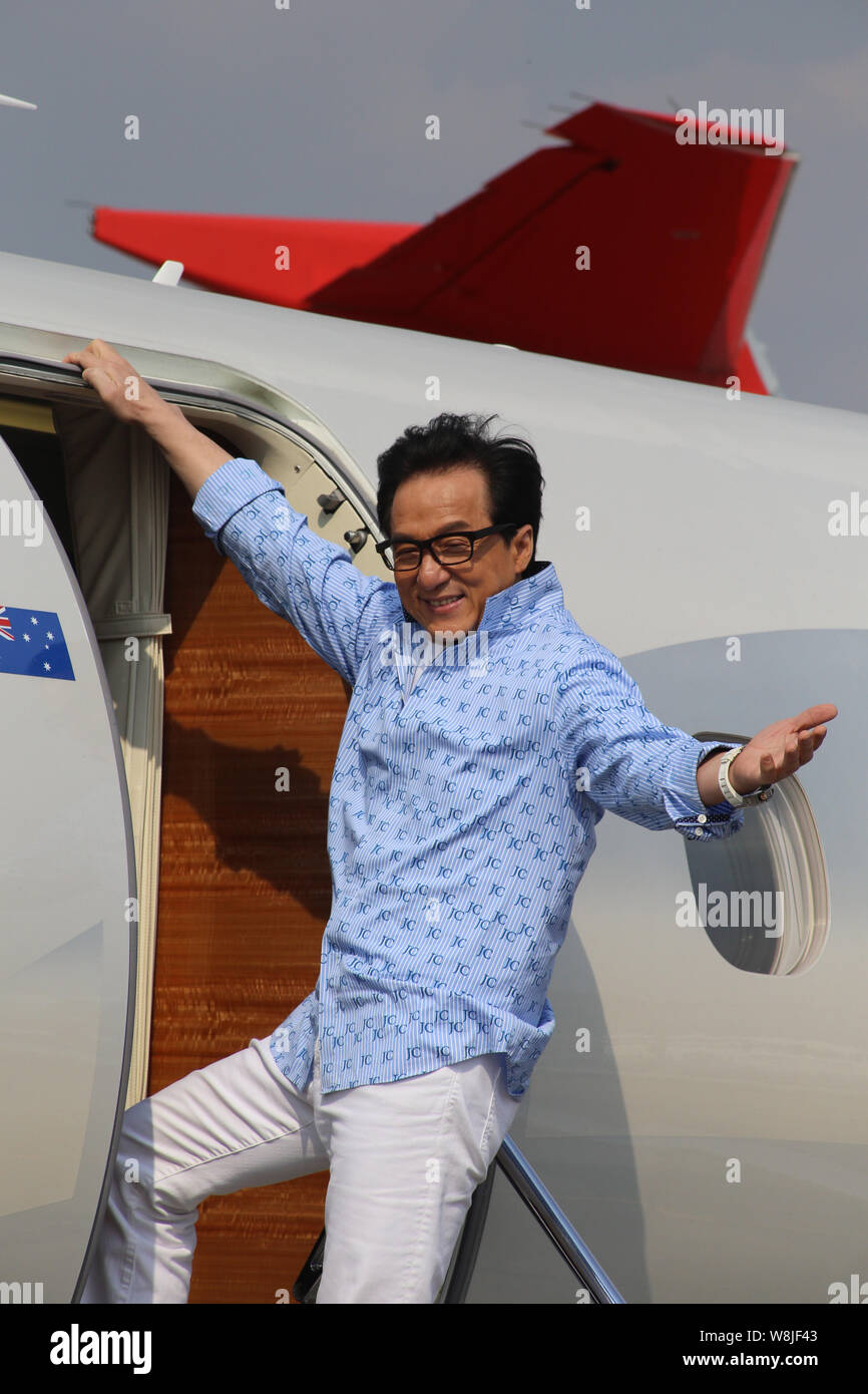 Hong Kong kungfu star Jackie Chan poses as he boards a Legacy 500 plane ...