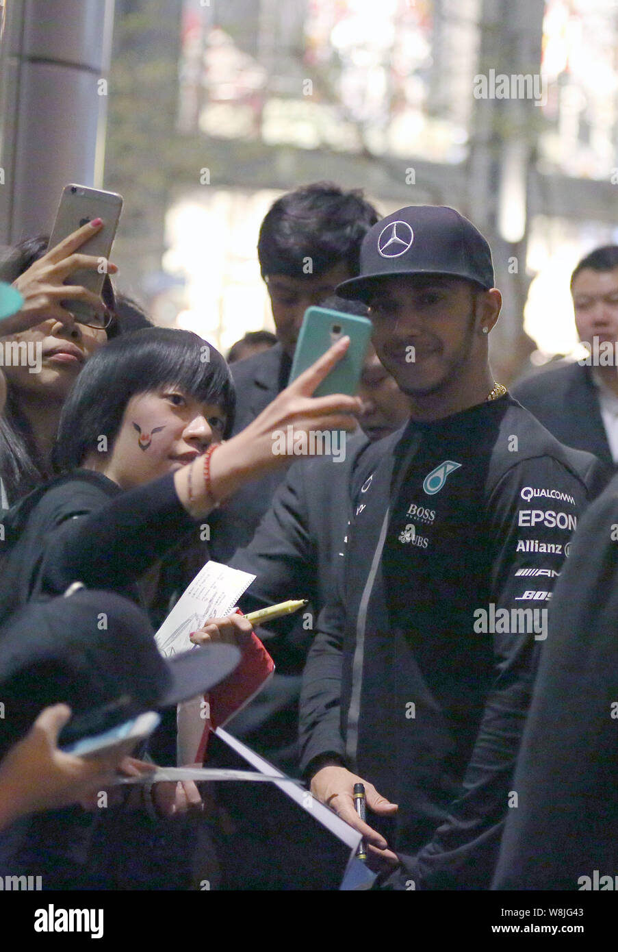British F1 driver Lewis Hamilton of Mercedes poses with a fan for a ...