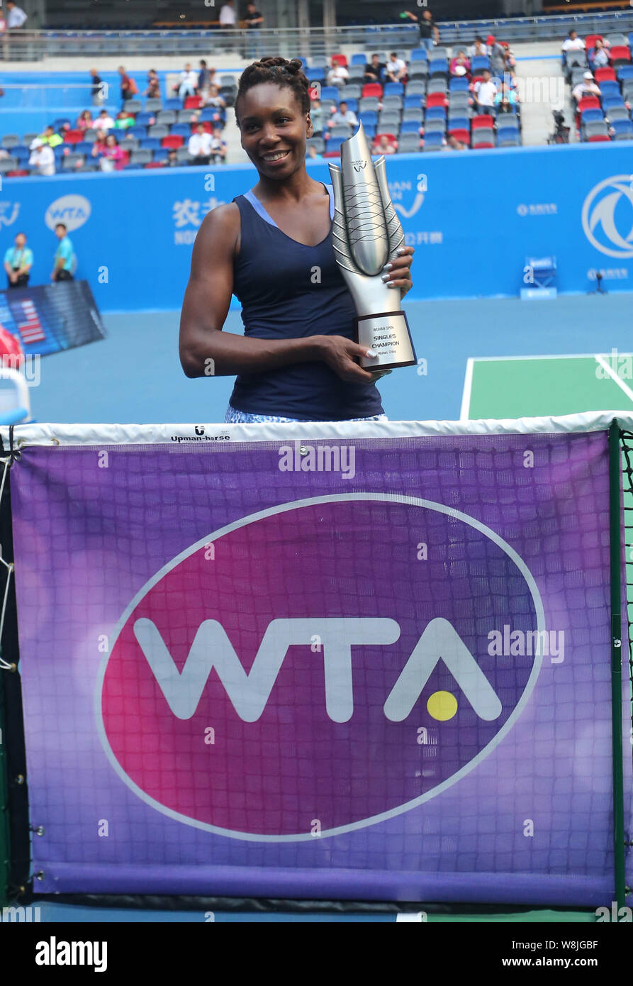 Venus Williams of the United States poses with her champion trophy ...